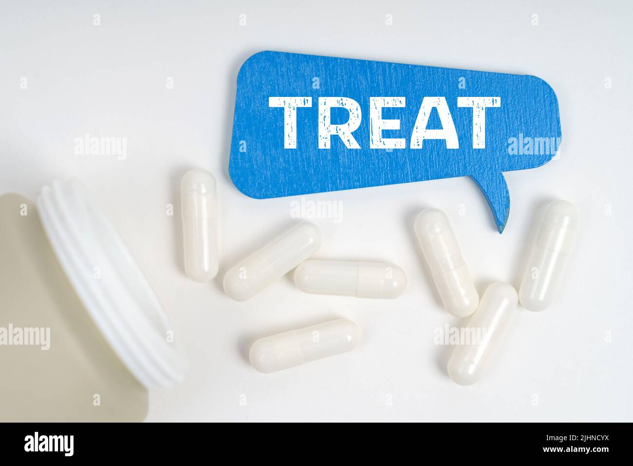 Medicine and health concept. On the table are pills and a blue sign ...