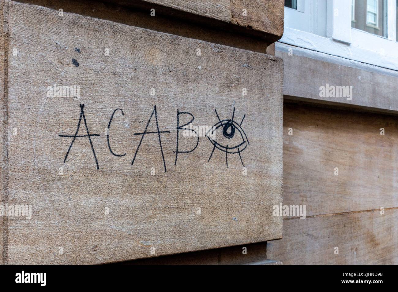 Next to an open eye the letters ACAB, standing for All Cops Are ...