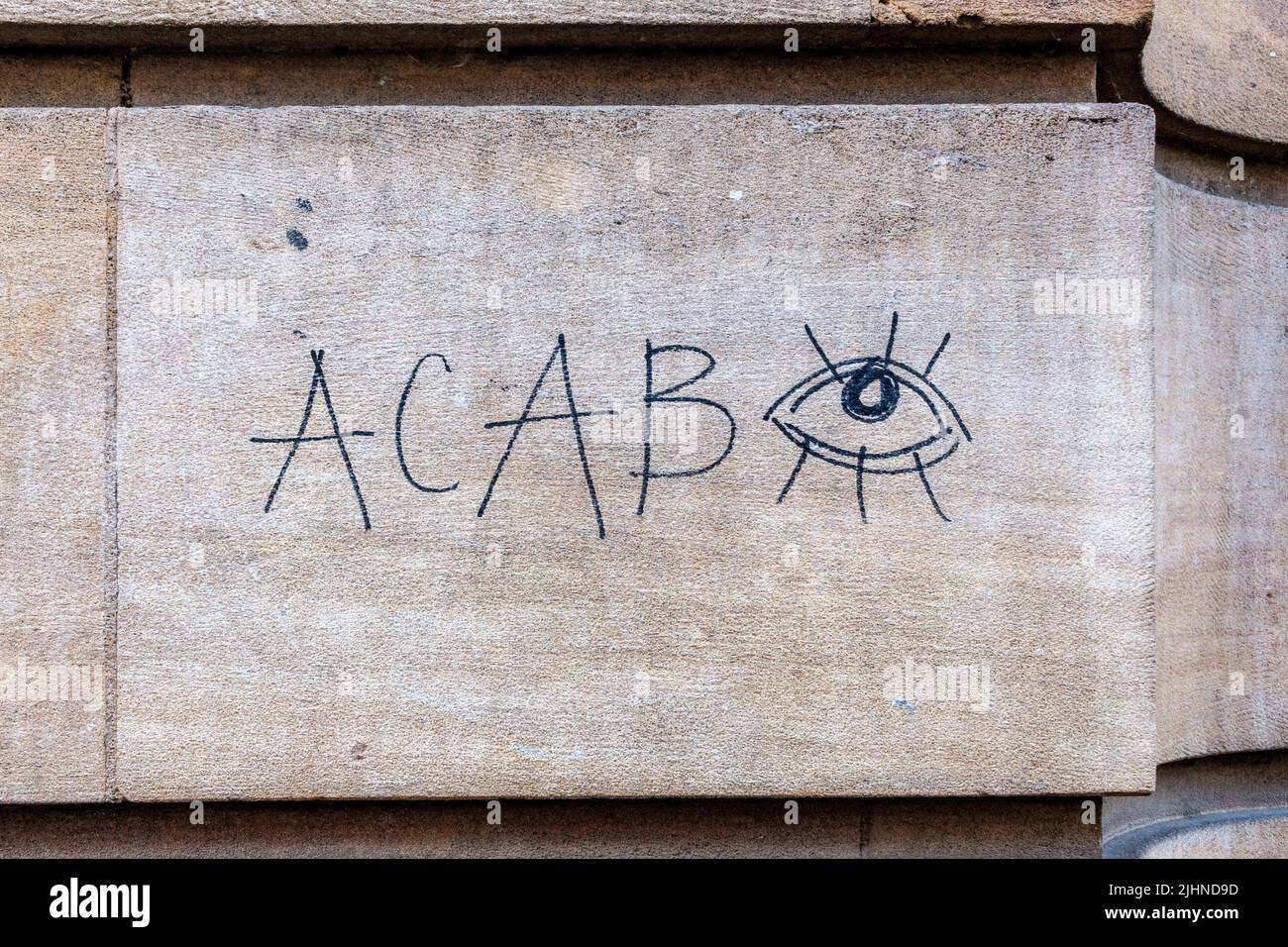Next to an open eye the letters ACAB, standing for All Cops Are ...