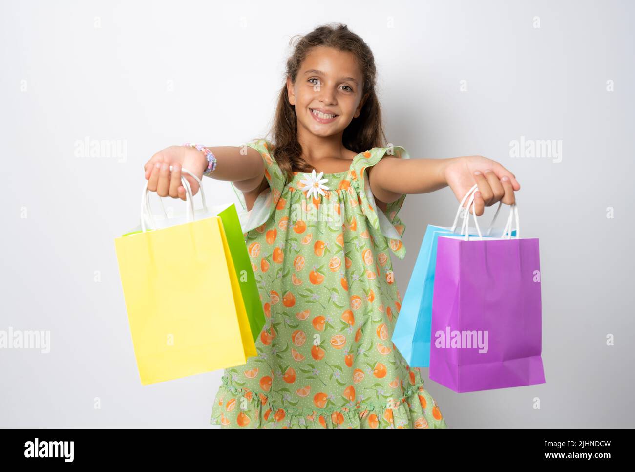 Sale. Cute little girl with many shopping bags on white background ...