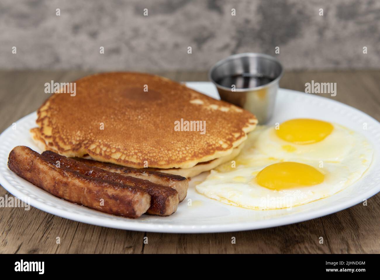 Standard American breakfast consisting of pancakes, fried eggs, and ...