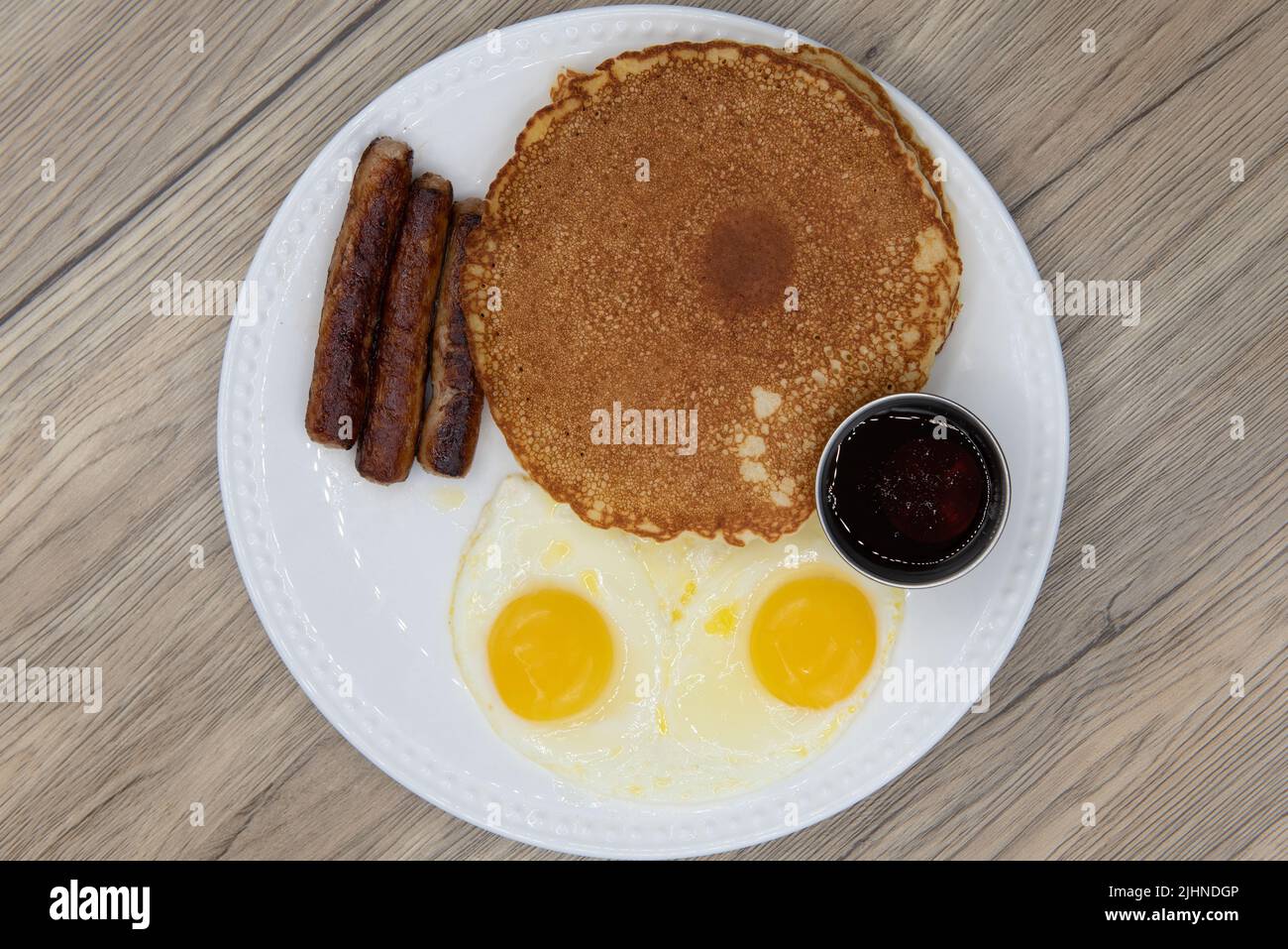 Overhead view of standard American breakfast consisting of pancakes ...
