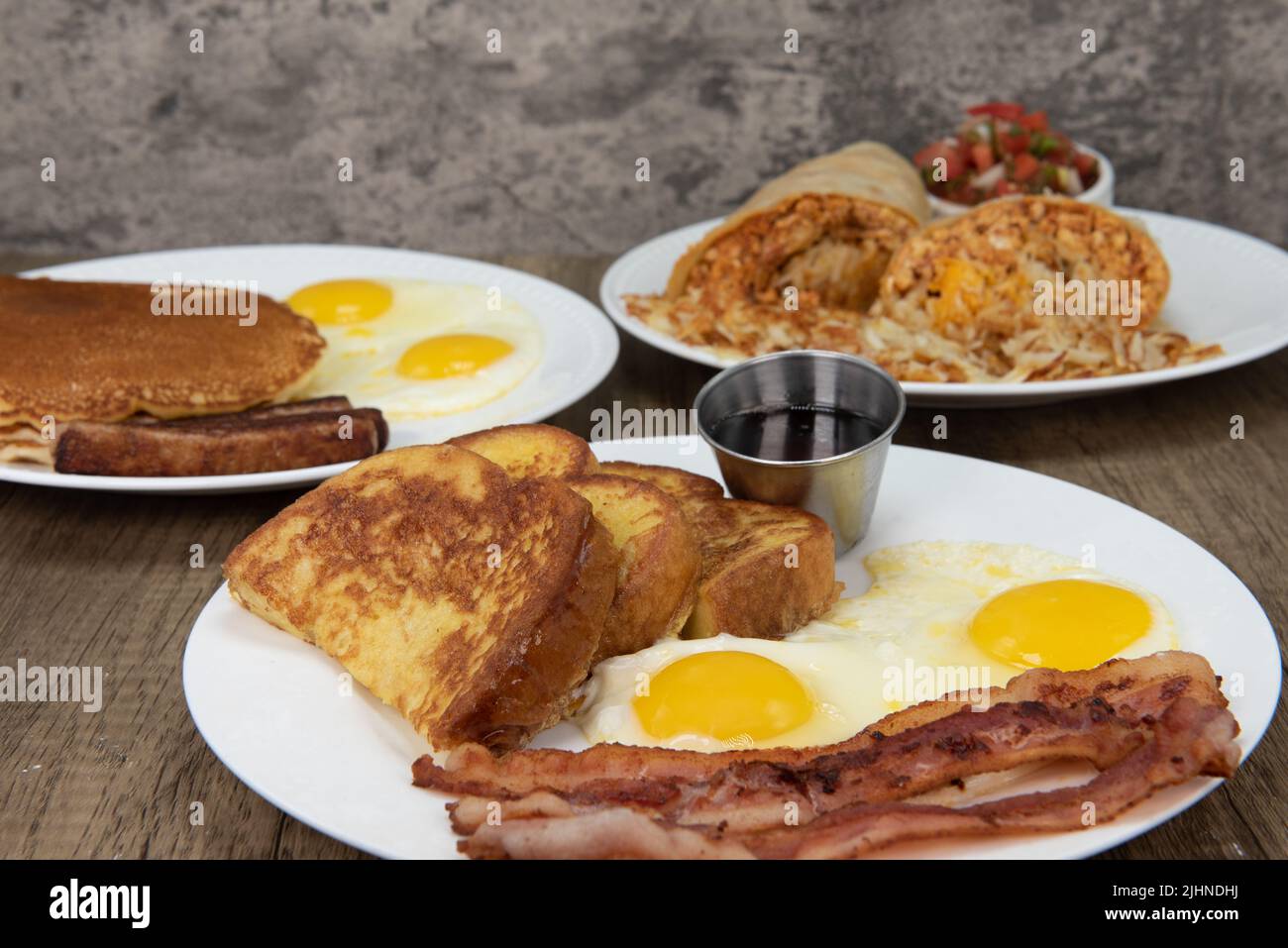 Standard American breakfast choices layed out on the table as a buffet ...
