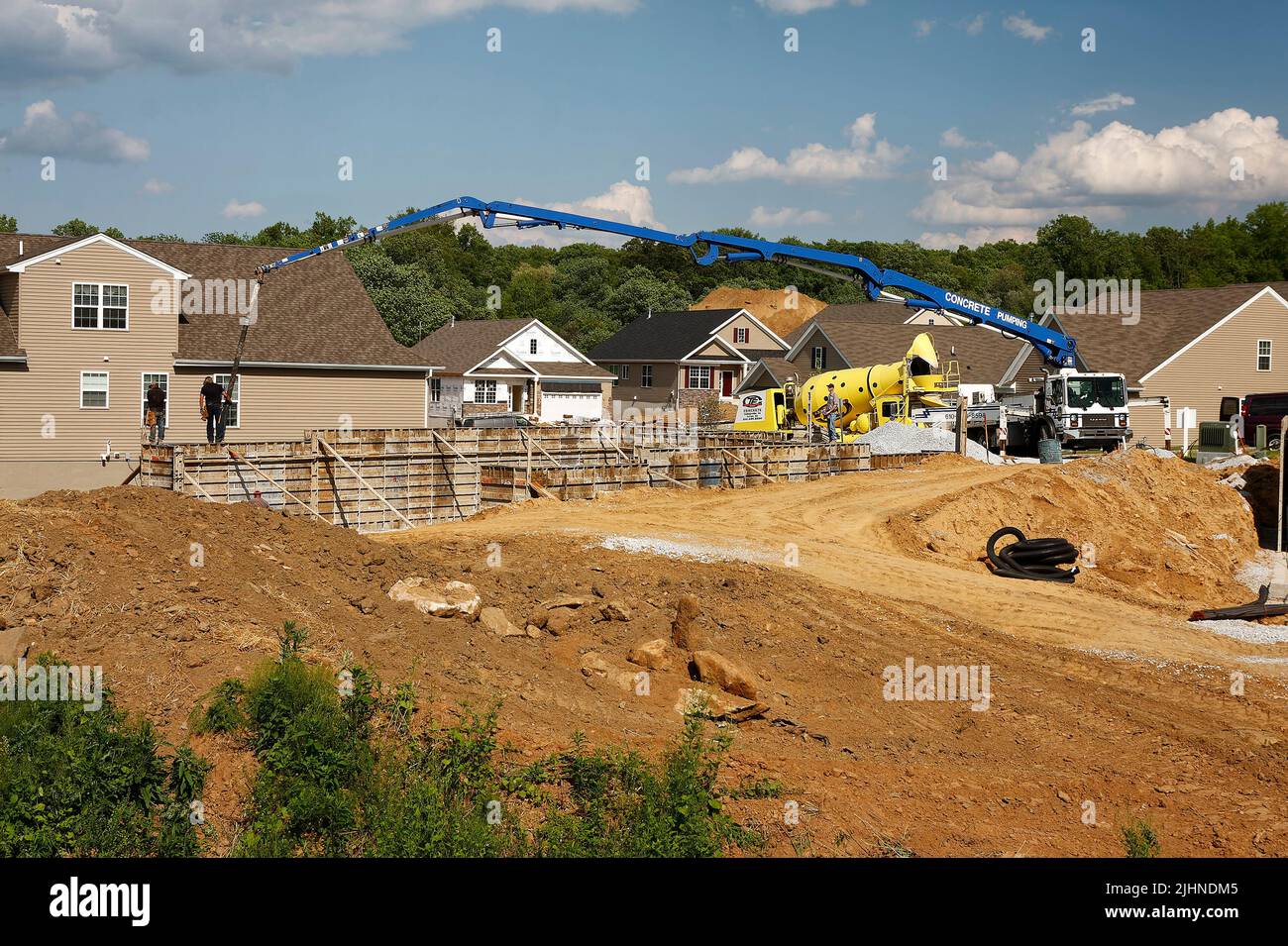 new house construction, heavy equipment, concrete foundation being ...