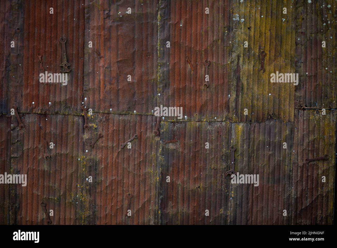 Pieces of patched-together sheet metal make up a door to an outbuilding ...