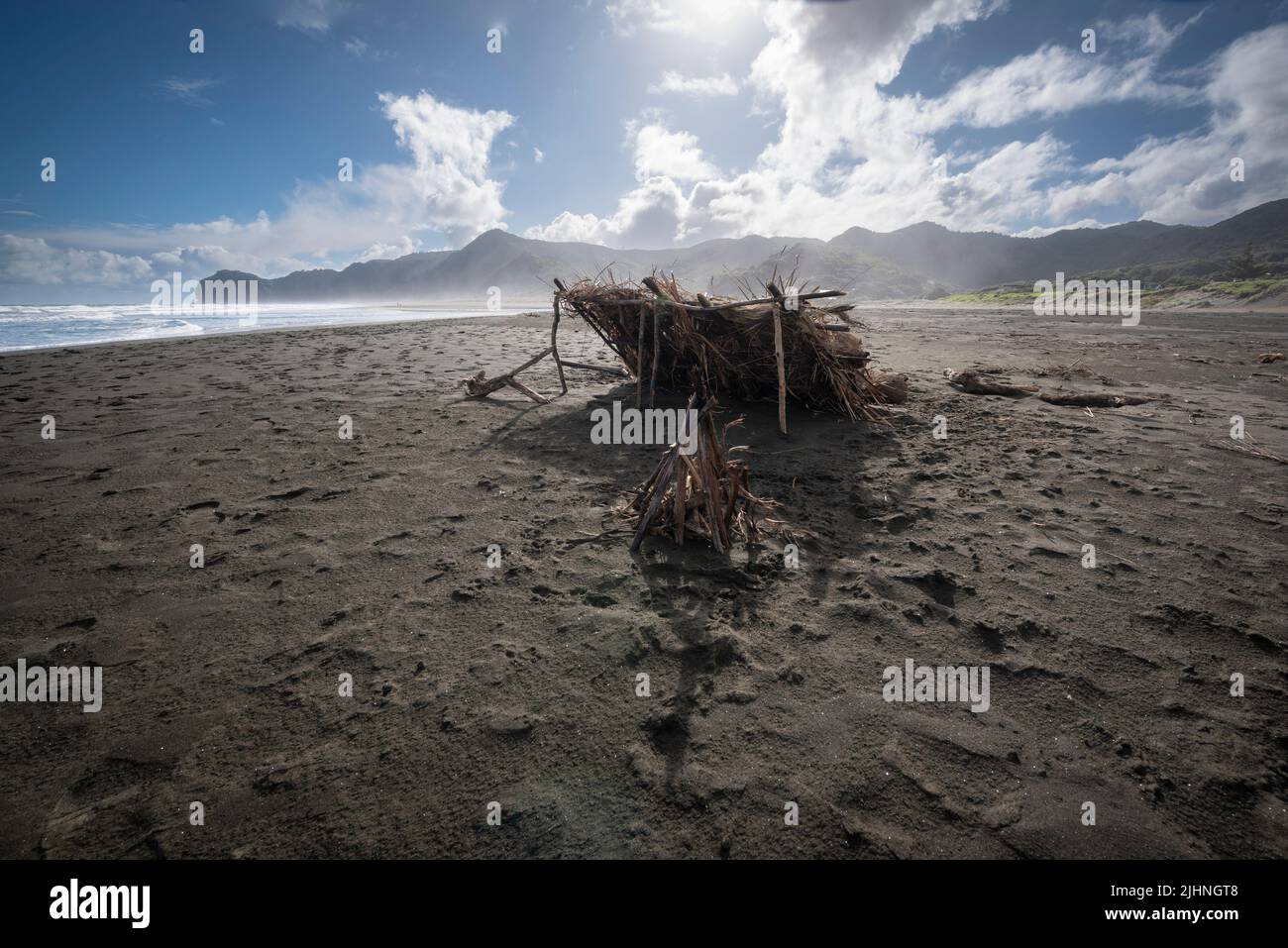 A small lean-to for shelter from the sun built by surfer's at Piha ...