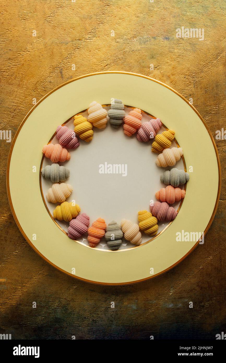 colorful Sea Conch Shells "Conchiglioni" pasta arrangement in circle on ...