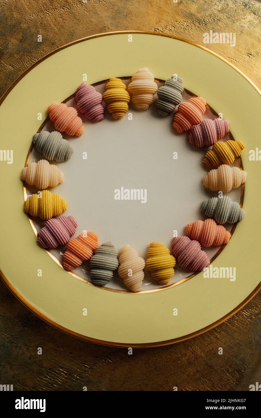 colorful Sea Conch Shells "Conchiglioni" pasta arrangement in circle on ...