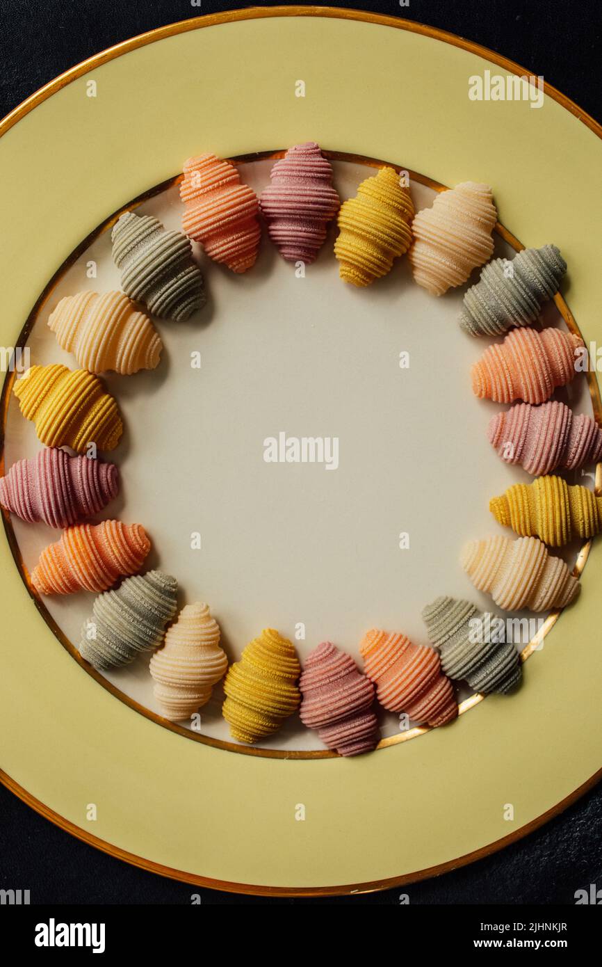 colorful Sea Conch Shells "Conchiglioni" pasta arrangement in circle on ...
