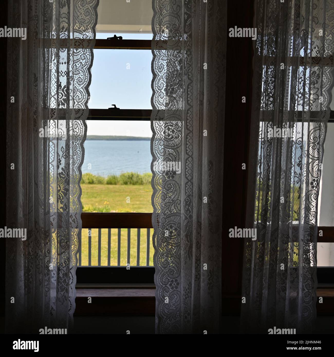 Looking out a window at the Raspberry Island lighthouse in the Apostle ...
