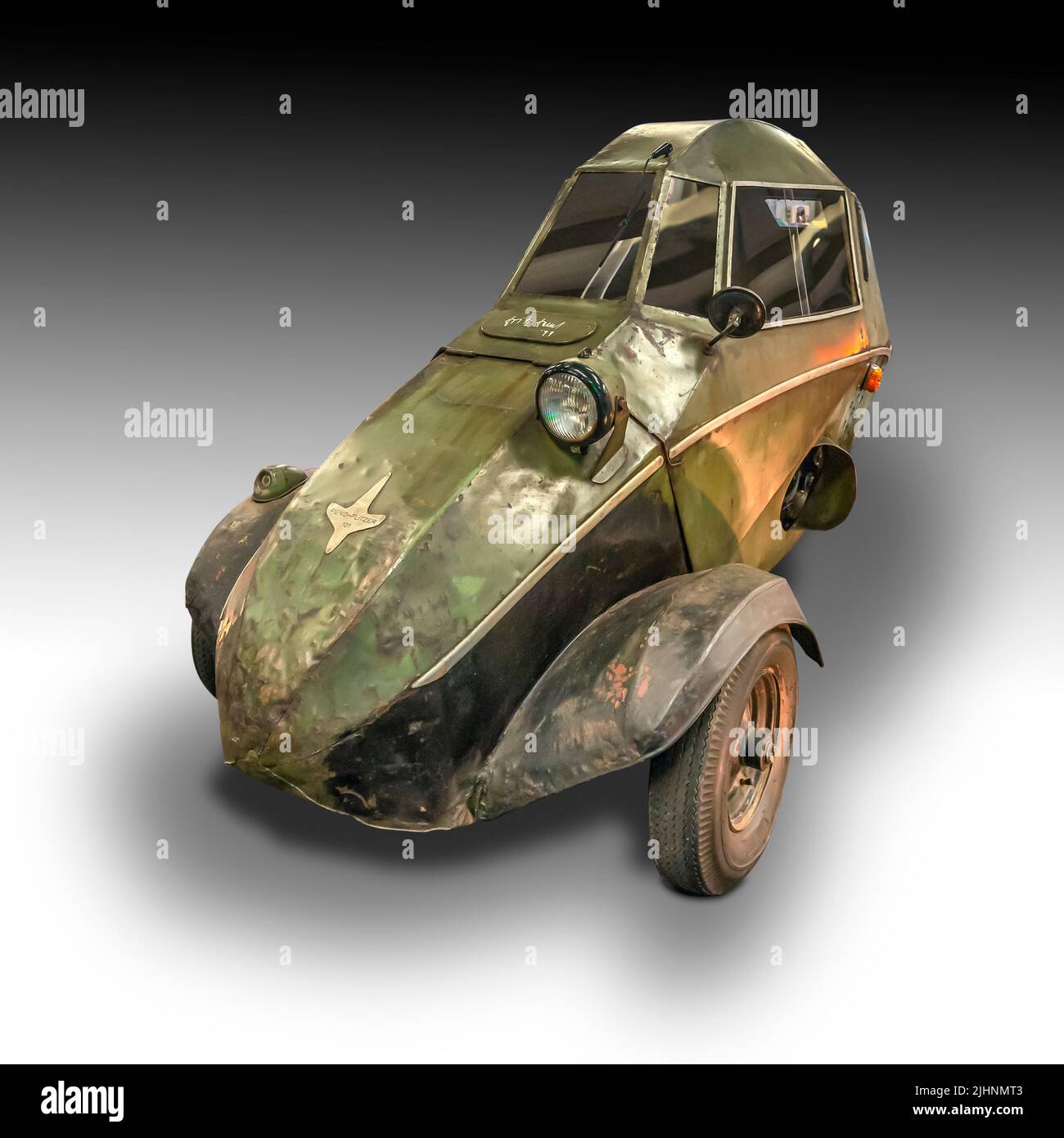 A side view of a 1950 Fend Flitzer Micro car on a knocked out white ...