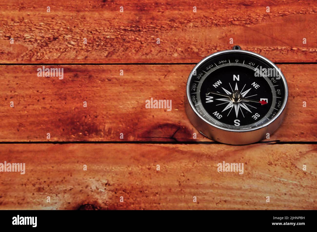 Navigation compass on wooden table background Stock Photo - Alamy