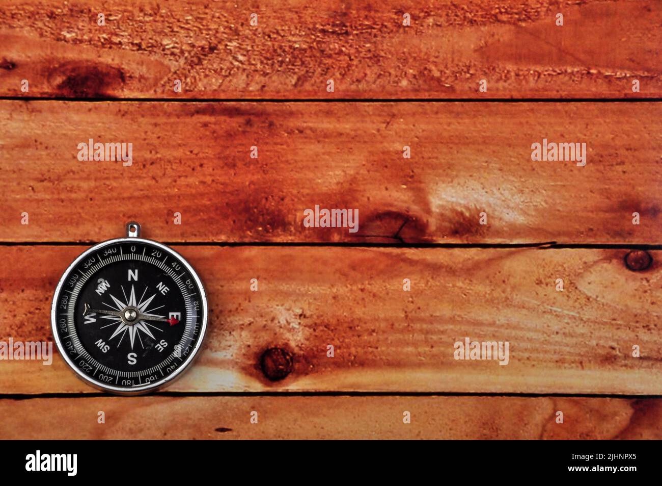 Navigation compass on wooden table background Stock Photo - Alamy