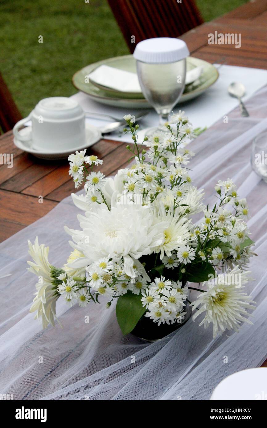 white gerbera flower arrangement in table setting for wedding ...