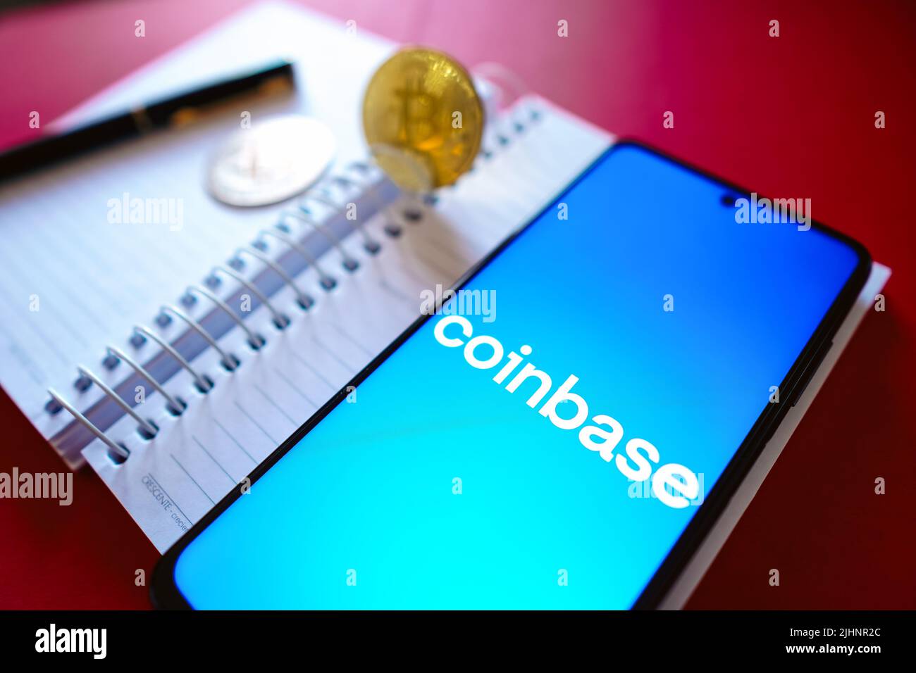 In this photo illustration, the Coinbase logo seen displayed on a ...