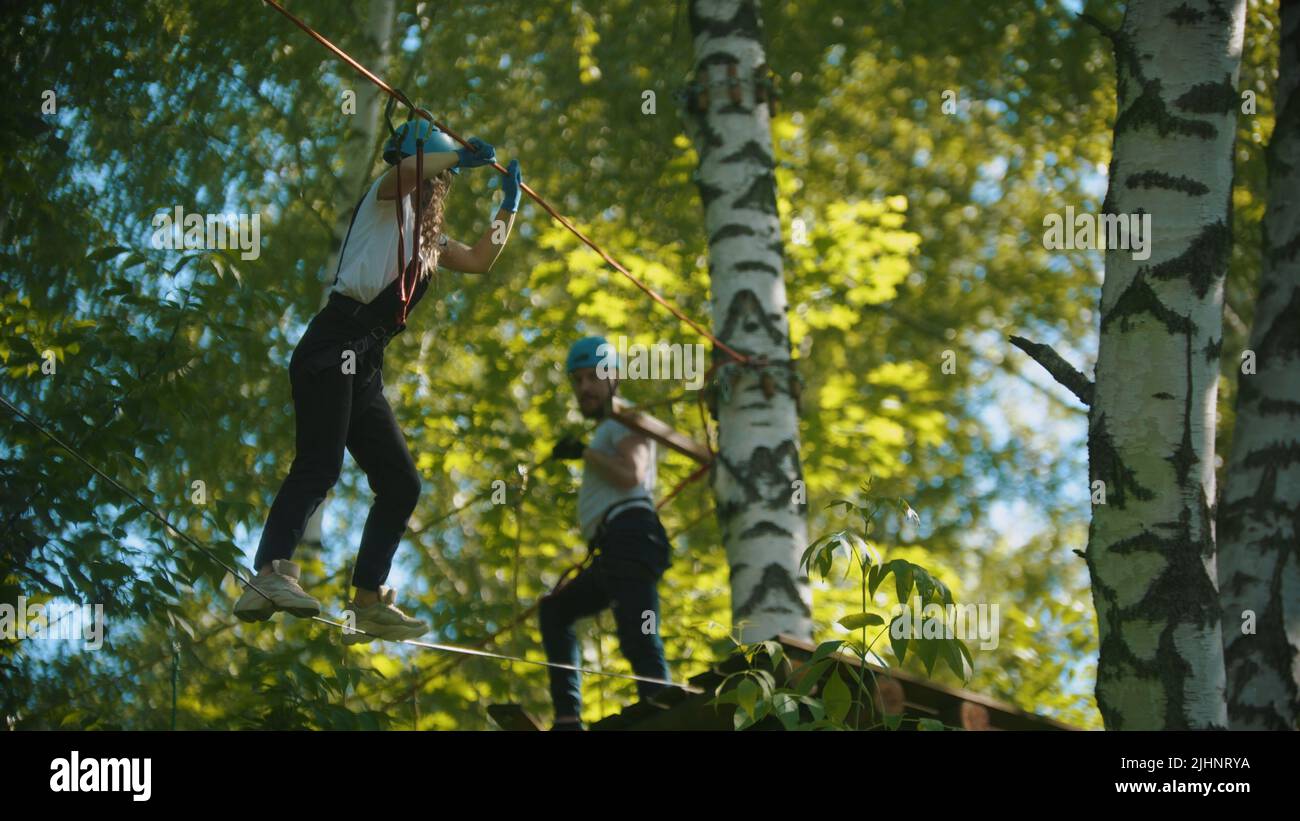 Man and woman crossing the rope bridge - an entertainment attraction in ...