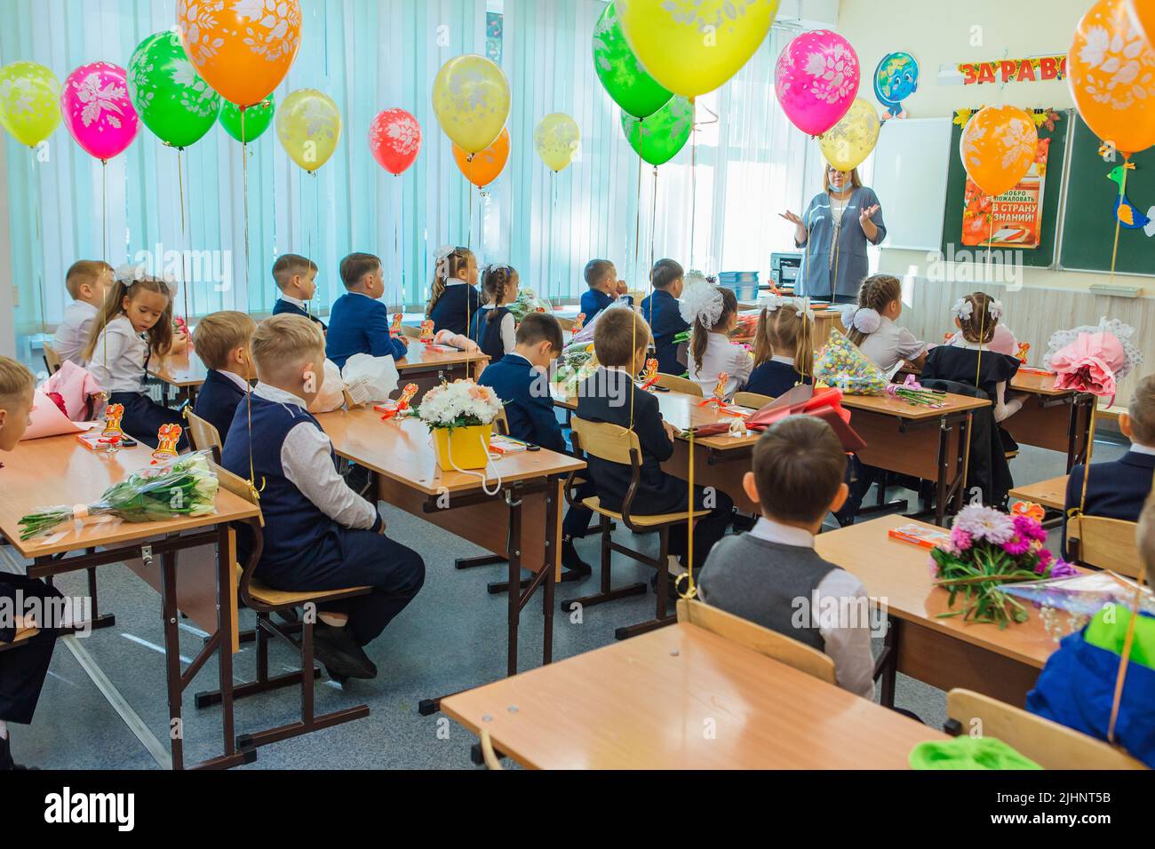 First-grade students and teacher are in school classroom at first ...