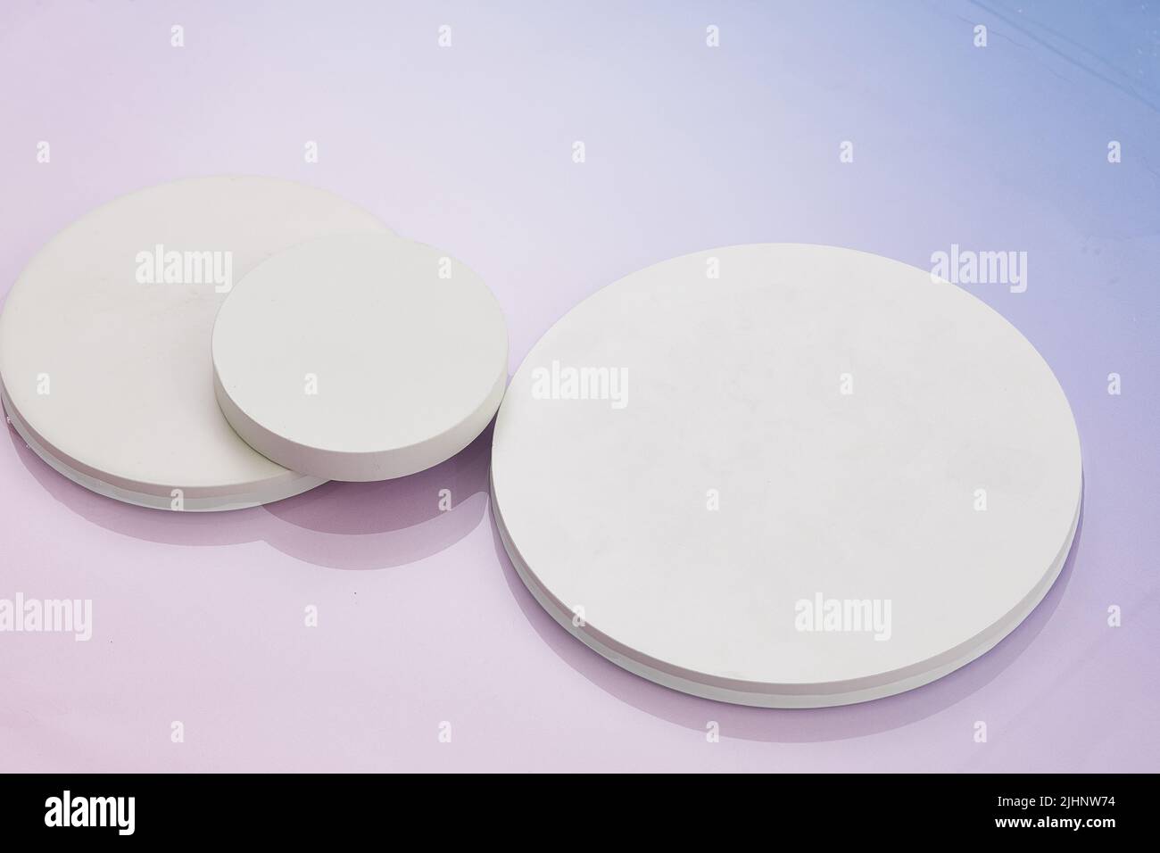 Thre circular white risers on gradient pnk to blue background. Mock up ...