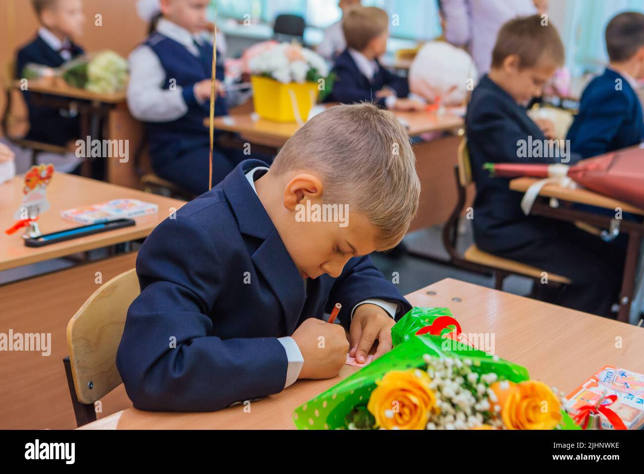 First-grade students and teacher are in school classroom at first ...