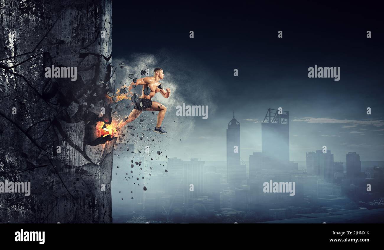 Male runner against dark background Stock Photo - Alamy