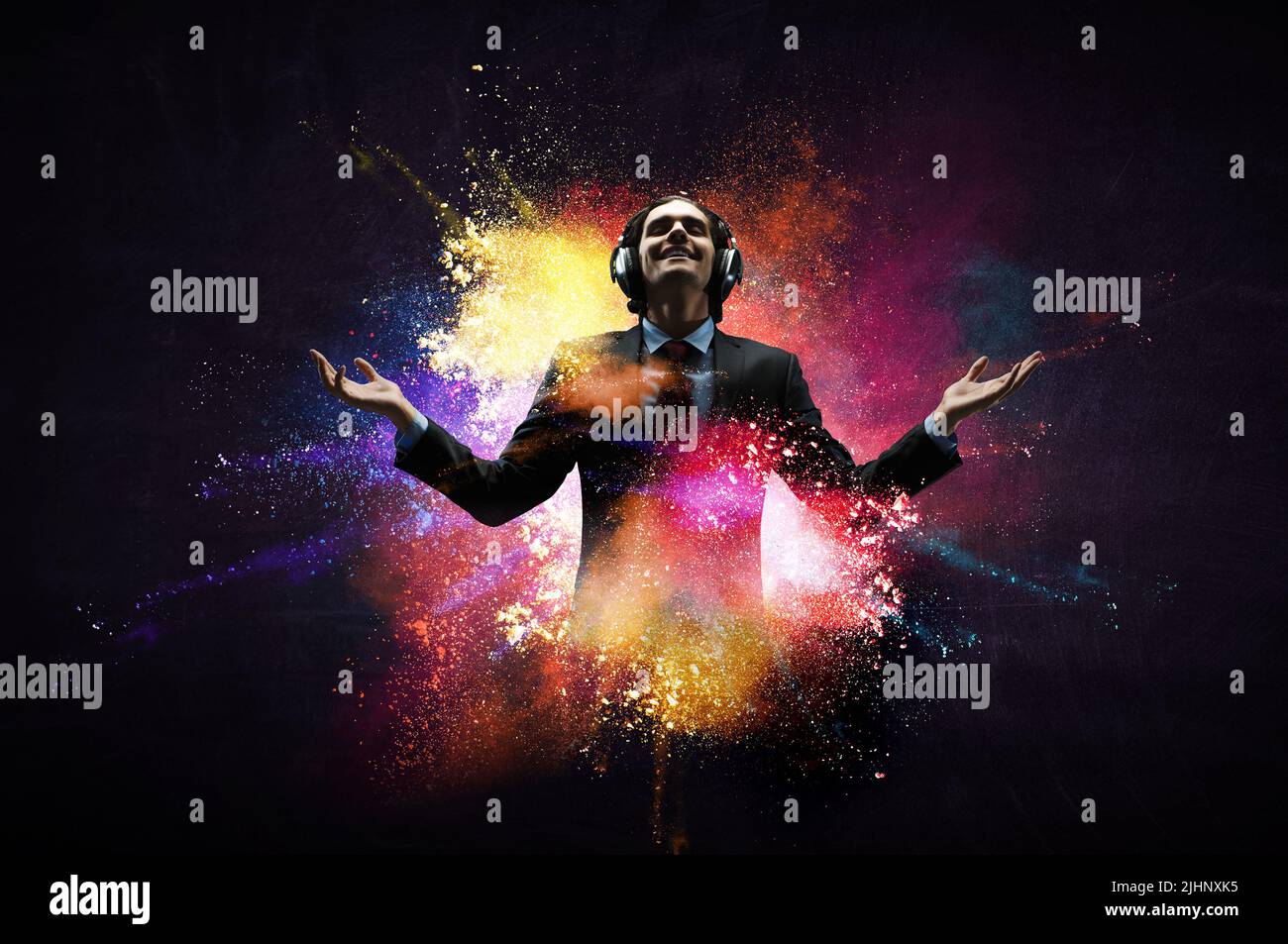 Young businessman with headphones . Mixed media Stock Photo - Alamy