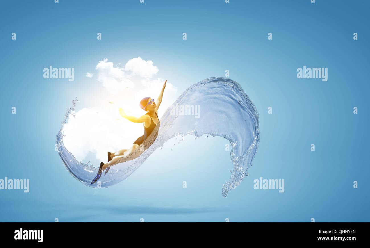 Professional woman swimmer on a wave Stock Photo - Alamy