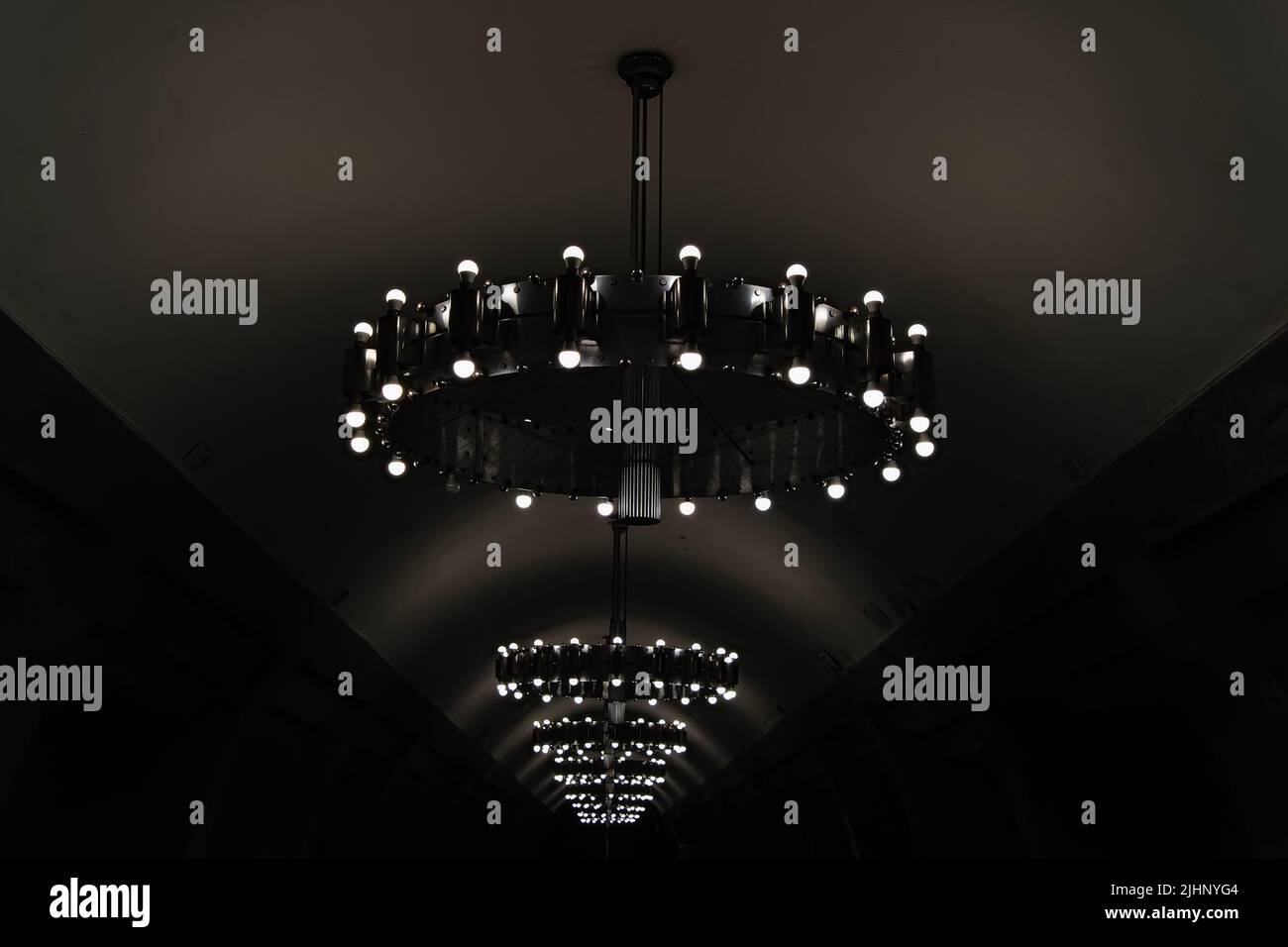 Line in litup lamps in the dark scary corridor Stock Photo - Alamy