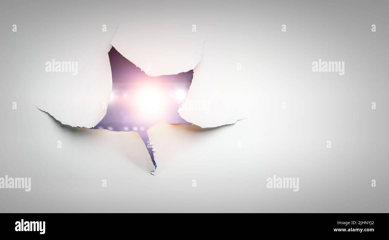 Hole in paper on white background Stock Photo - Alamy