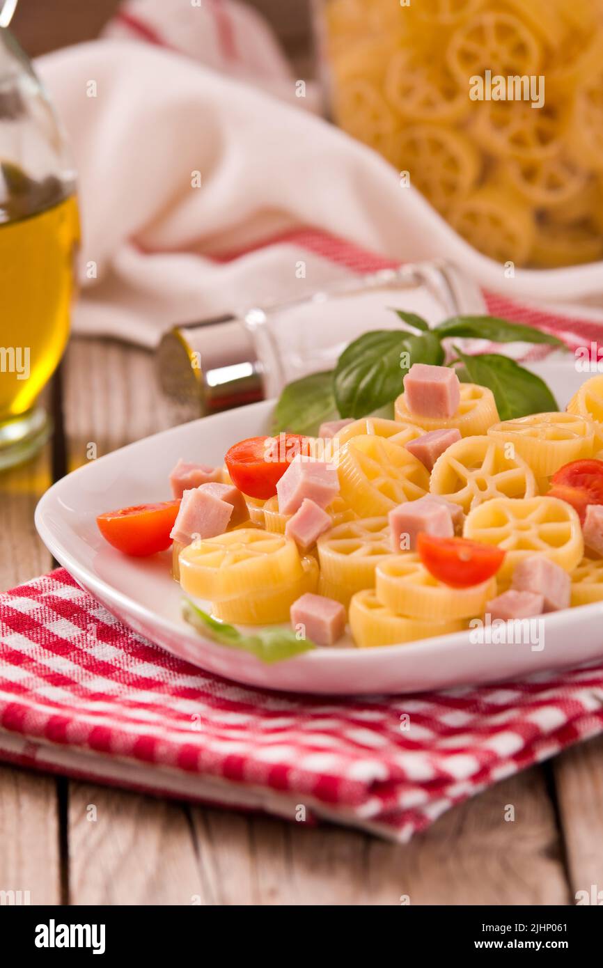 Ruote pasta with tomato and ham Stock Photo - Alamy
