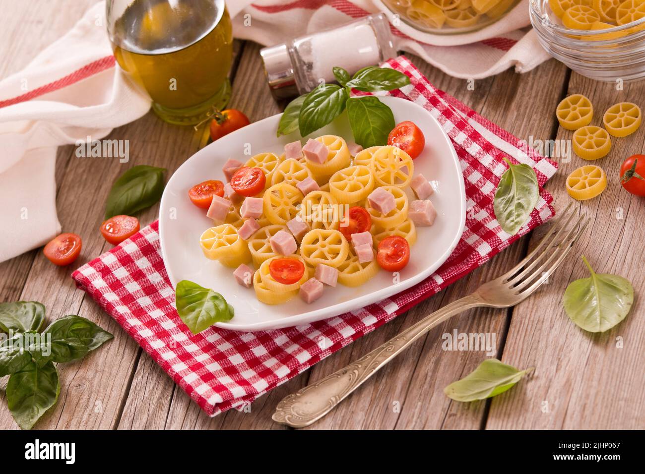 Ruote pasta with tomato and ham Stock Photo - Alamy