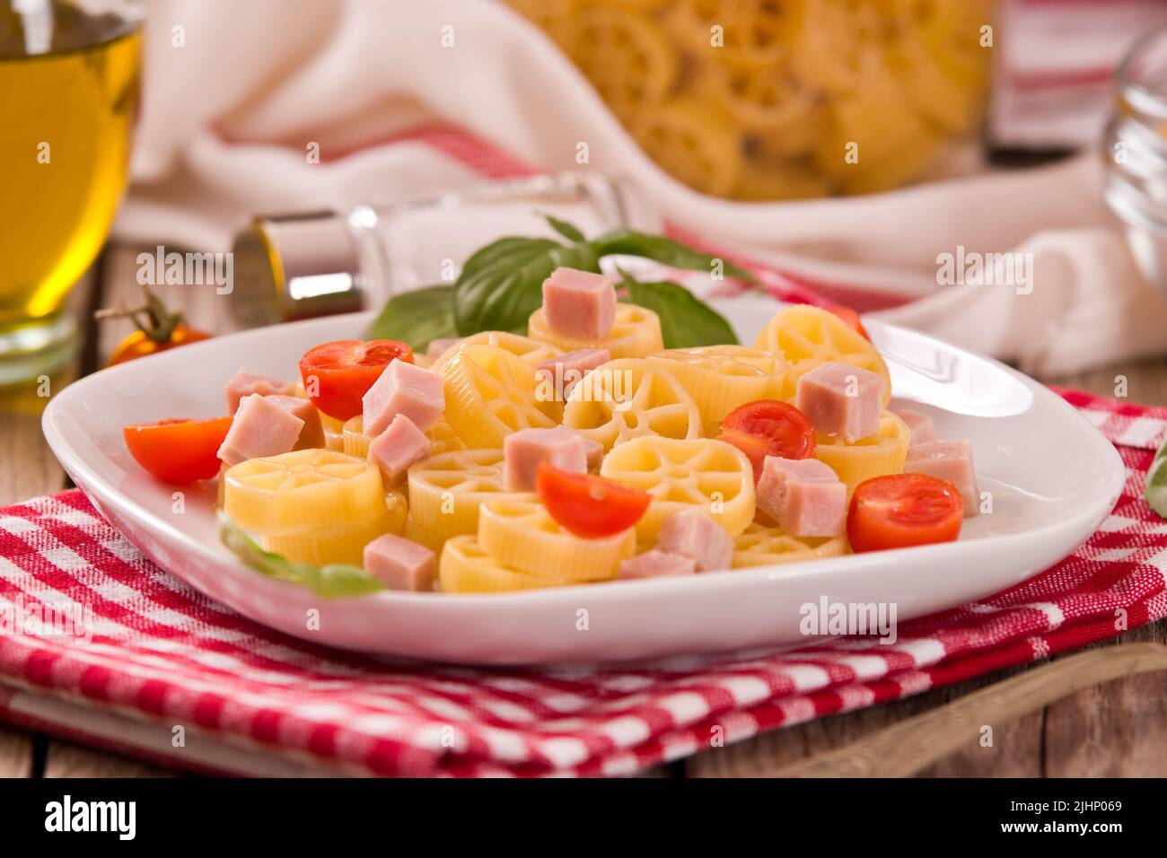 Ruote pasta with tomato and ham Stock Photo - Alamy