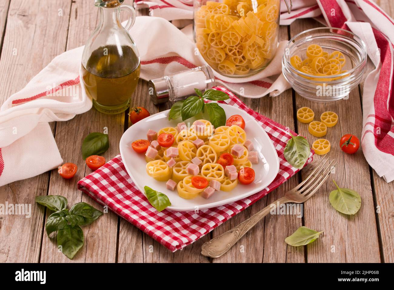 Ruote pasta with tomato and ham Stock Photo - Alamy