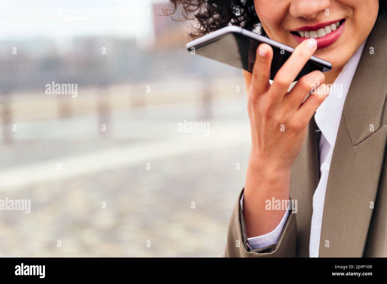 mouth of a smiling woman recording a voice message Stock Photo - Alamy