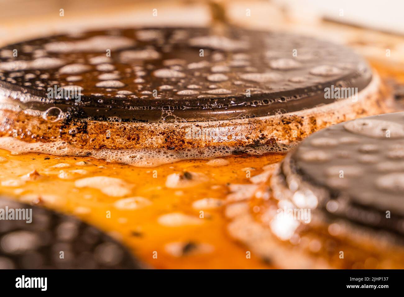 The surface of a very dirty kitchen electric stove in a bright ...