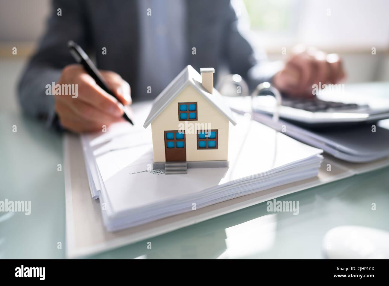 Person Hand Doing Property Tax Calculation Using Calculator Of House ...