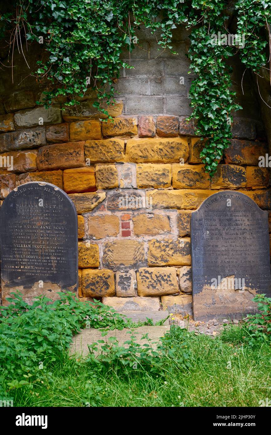 Old gravestones in St Jame's cemetery against sandstone wall Stock ...