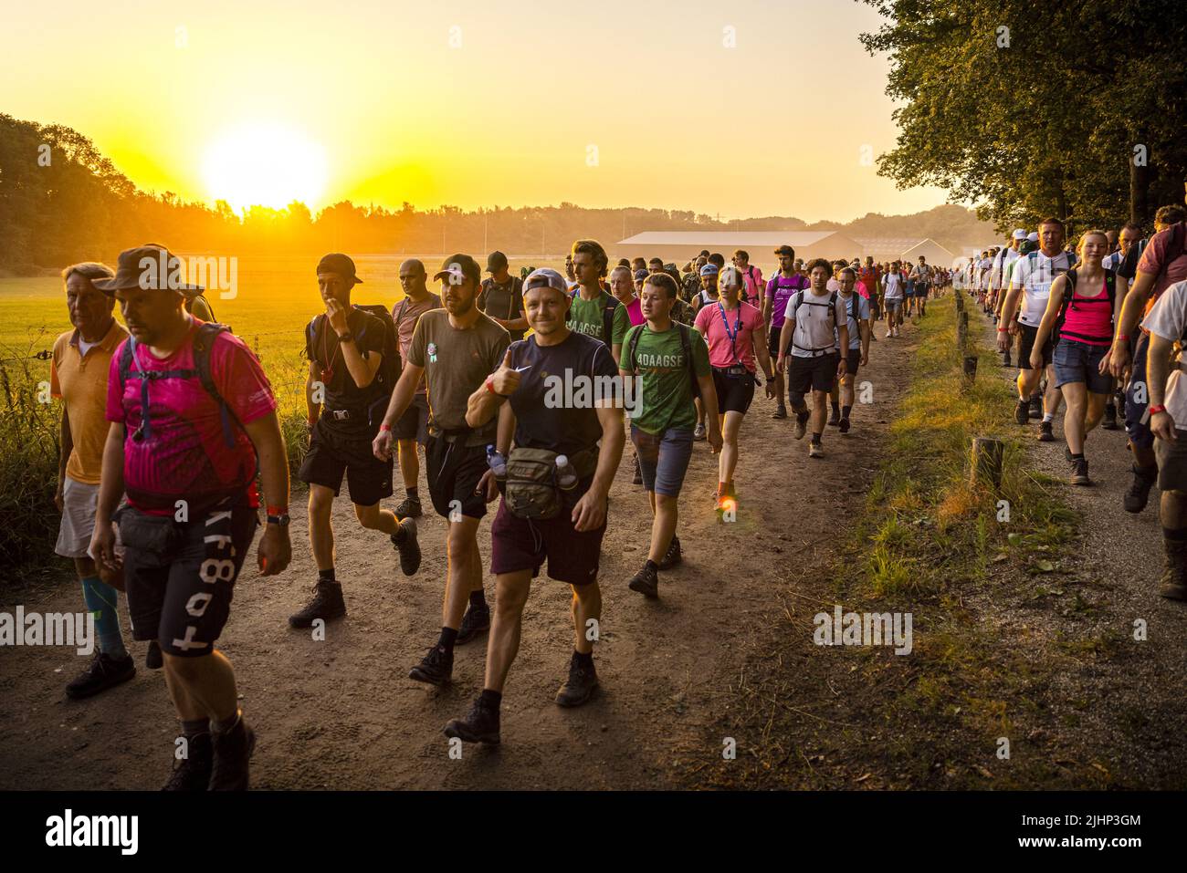 2022-07-20 06:07:23 NIJMEGEN - Walkers during the sunrise on the route ...