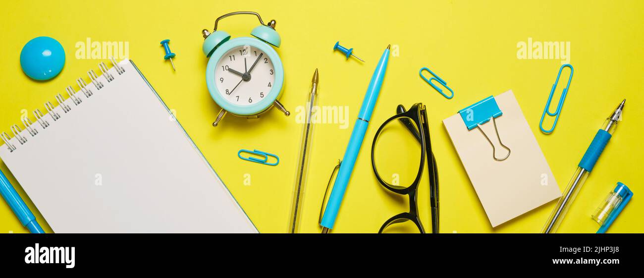 Notebook on a spring for notes and stationery lie on a yellow ...