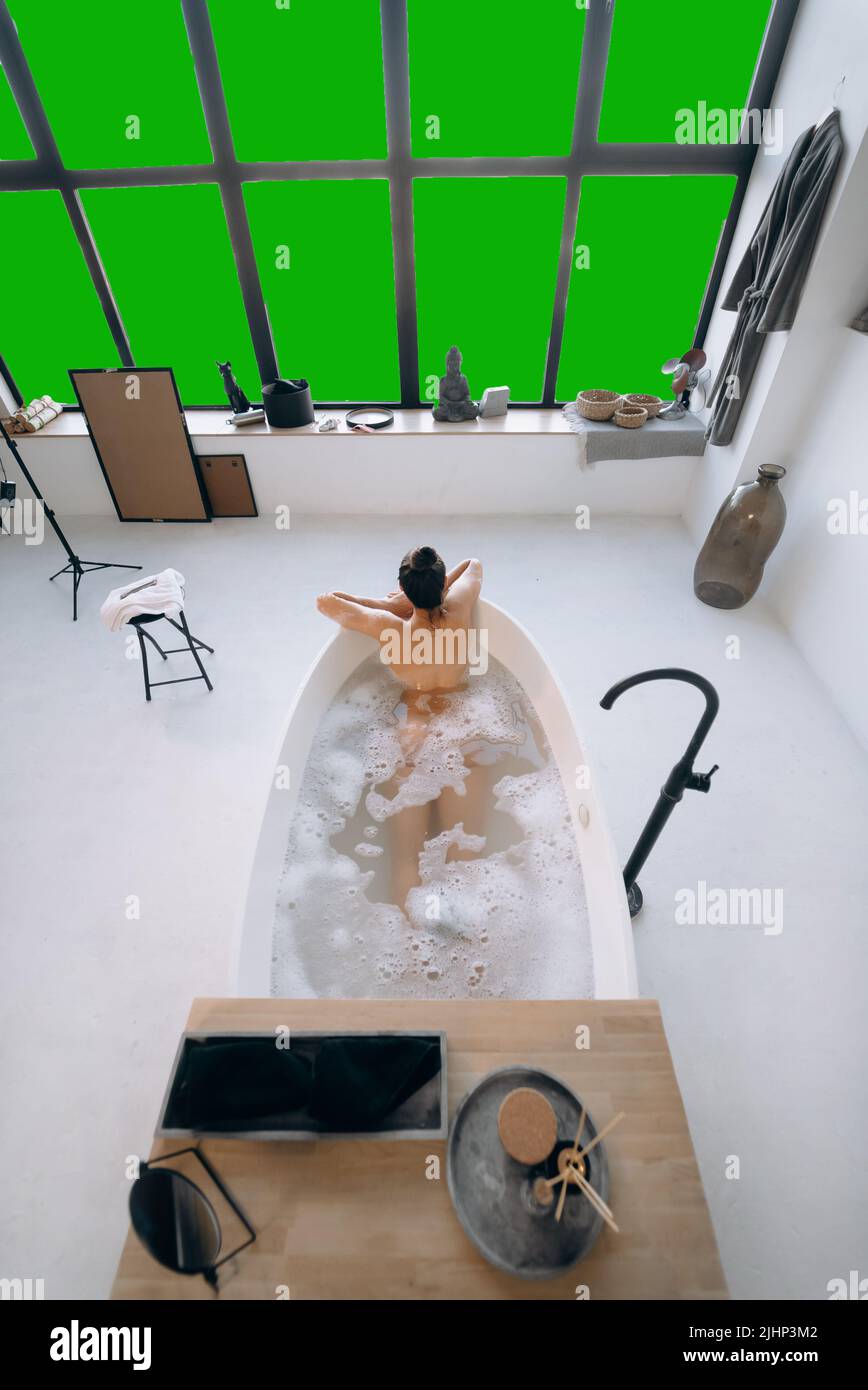 Relaxed lady taking bath, enjoying and relaxing while lying in bathtub ...