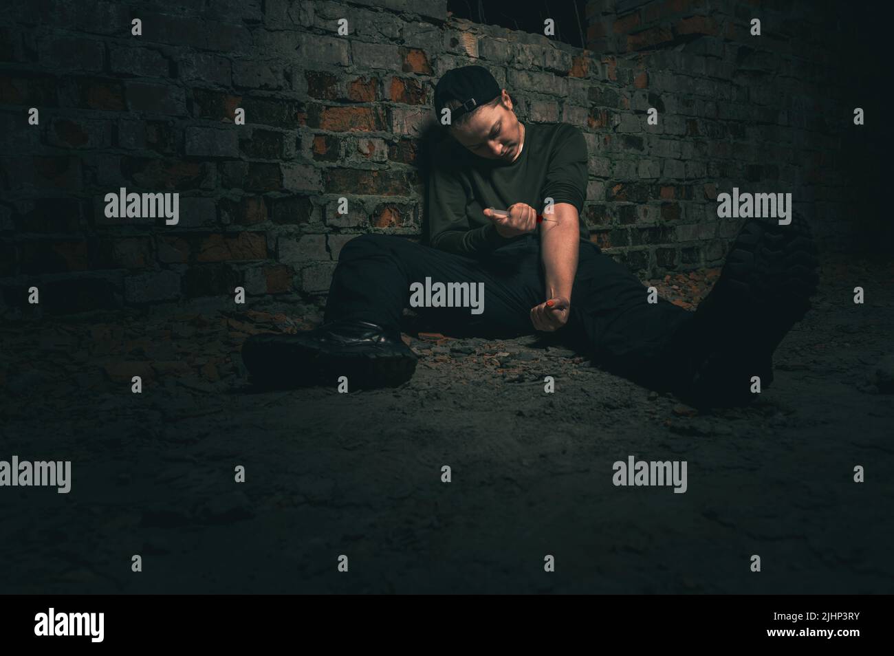 Dope obsessed woman sitting with syringe. Woman drug addict with a ...