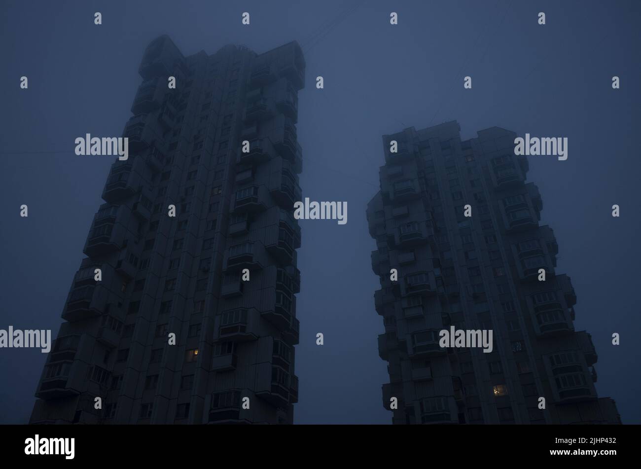 Two tall residential buildings in the form of a tower, immersed in a ...
