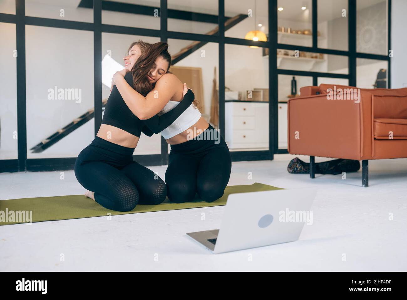 Two girlfriends hug each other after yoga Stock Photo - Alamy