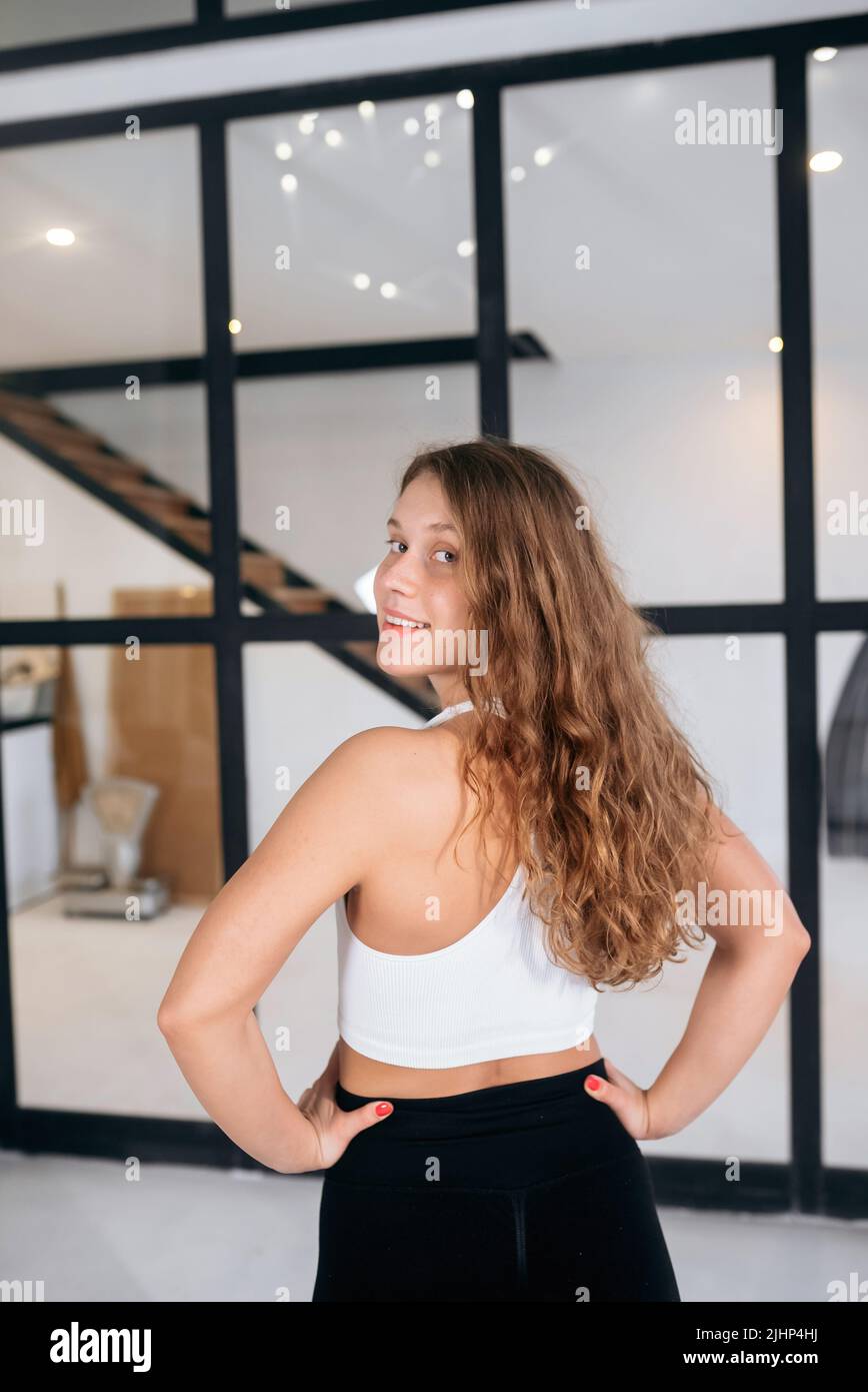 Woman in a tracksuit looks at the camera over her shoulder Stock Photo ...
