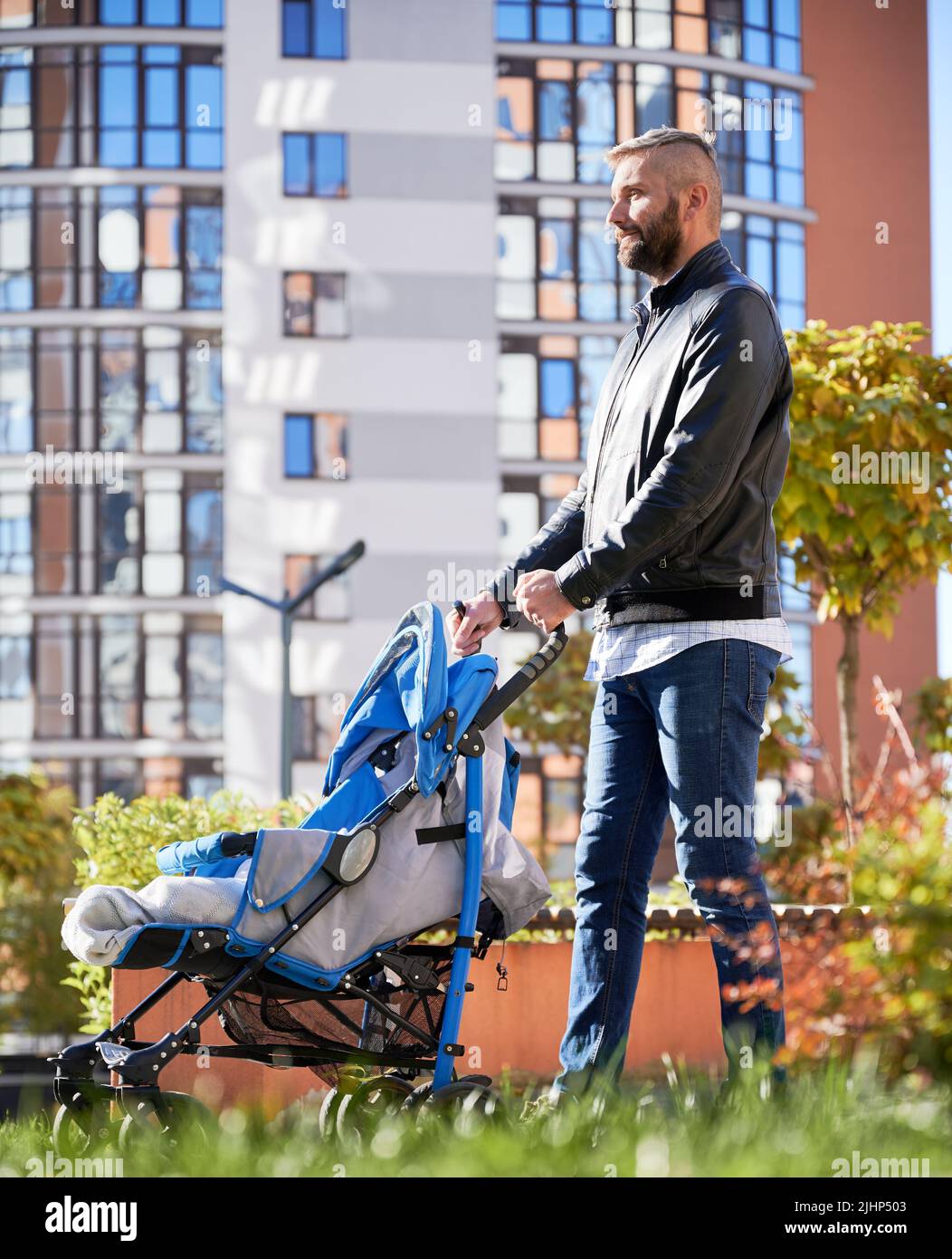 Father spending time with newborn kid outside. Young bearded man ...