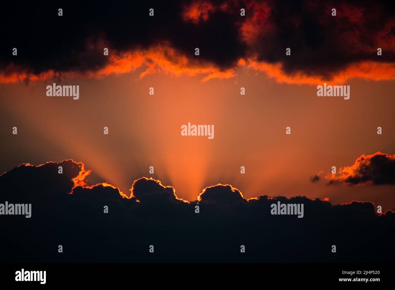 Sunset. From below, rays of light emerge from the clouds. And clouds ...