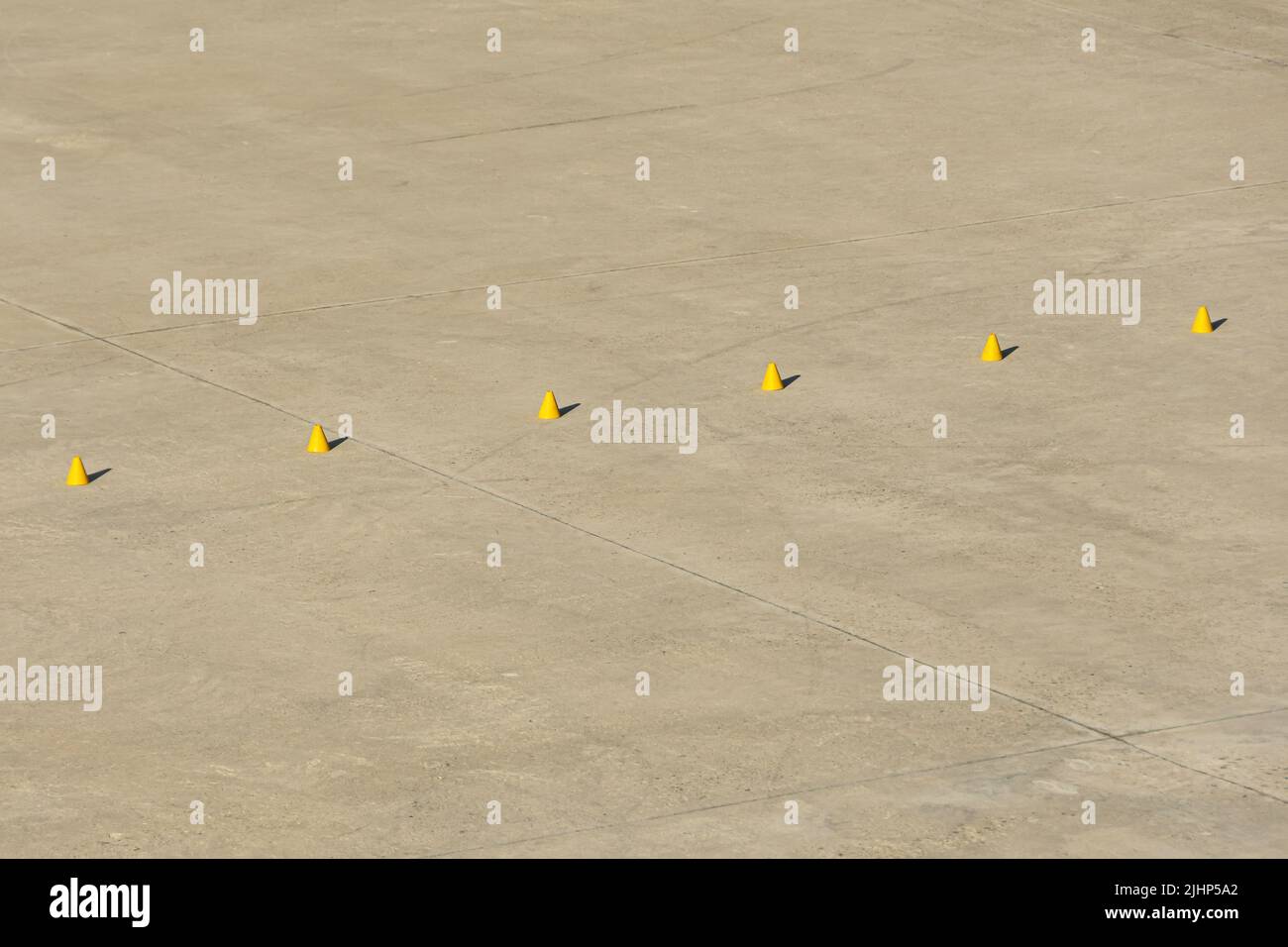 Small yellow cones on the playground for roller skating and training ...