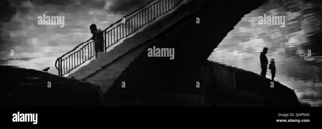 Contemplator and Sensei. Inverted reflection on the water Stock Photo ...