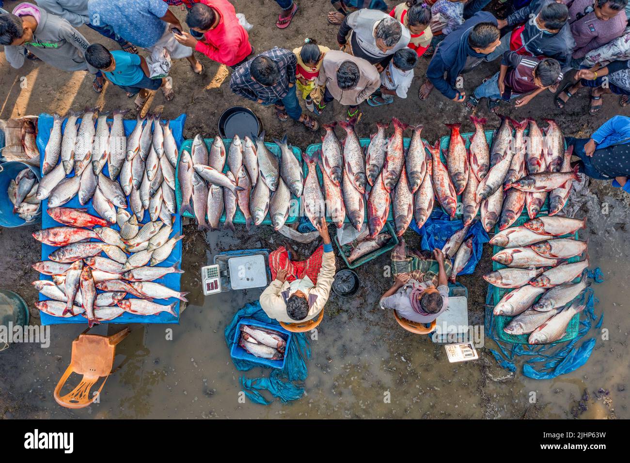 Aerial view of fish being sold at a bustling village fair in rural ...