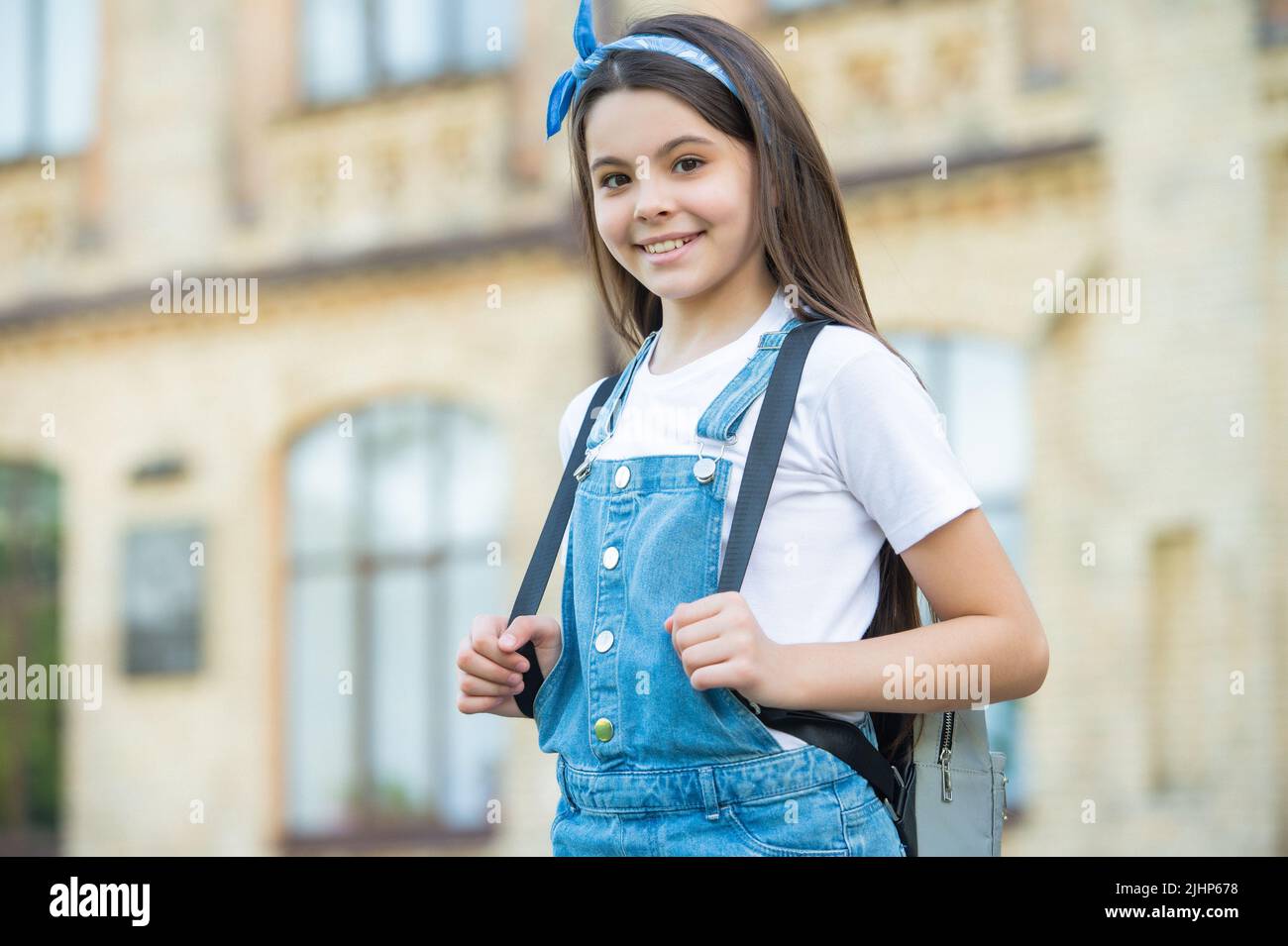 cheerful denim girl with backpack posing outdoor Stock Photo - Alamy