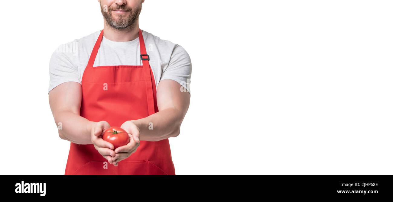 cropped view of man in apron with tomato vegetable isolated on white ...